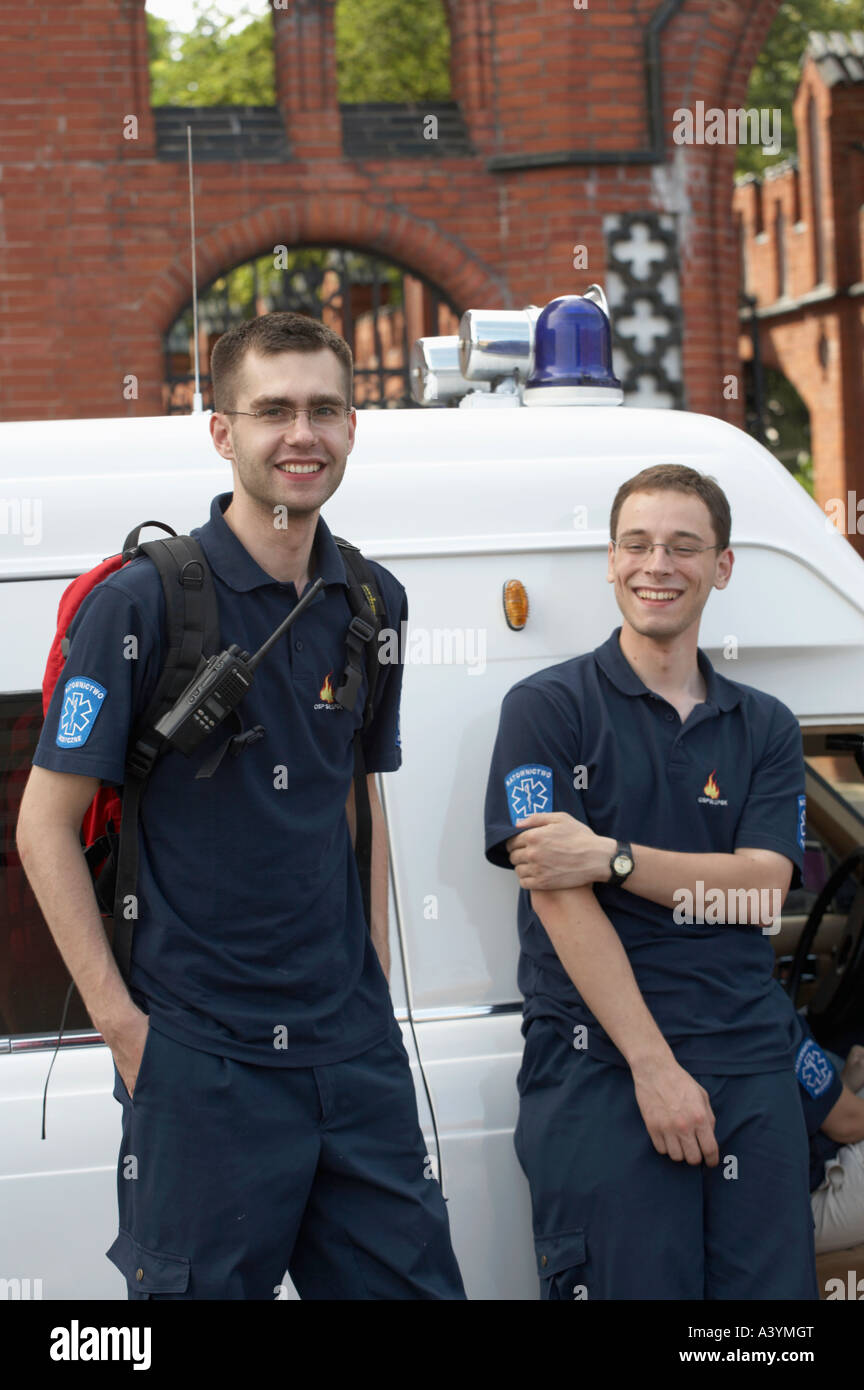 Two ambulance men on standby beside their ambulance Stock Photo - Alamy
