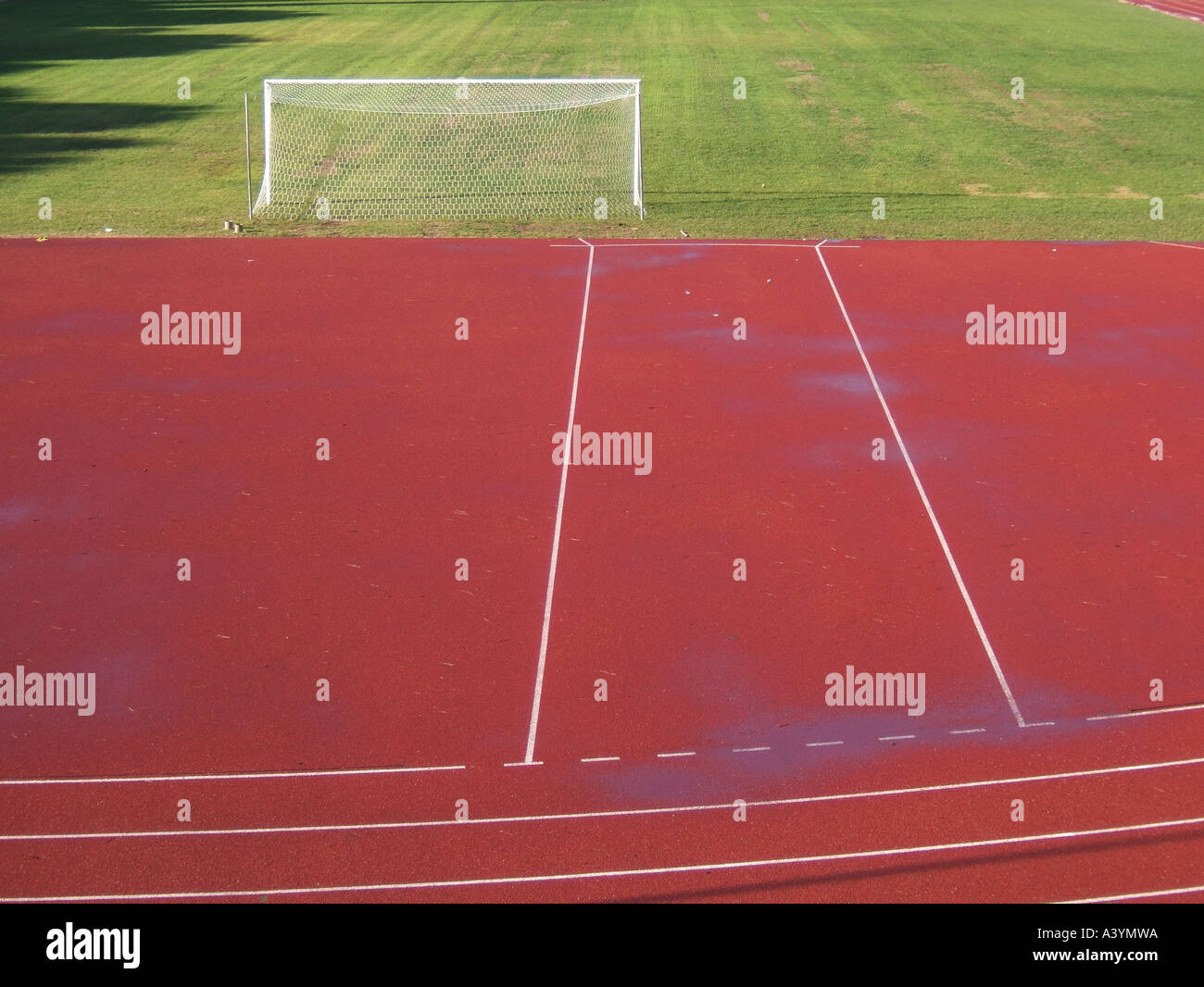 football goal posts and athletic track Stock Photo - Alamy