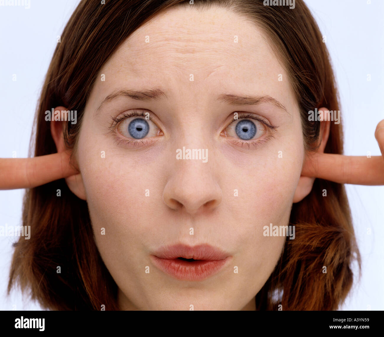 Woman with fingers in ears hi-res stock photography and images - Alamy