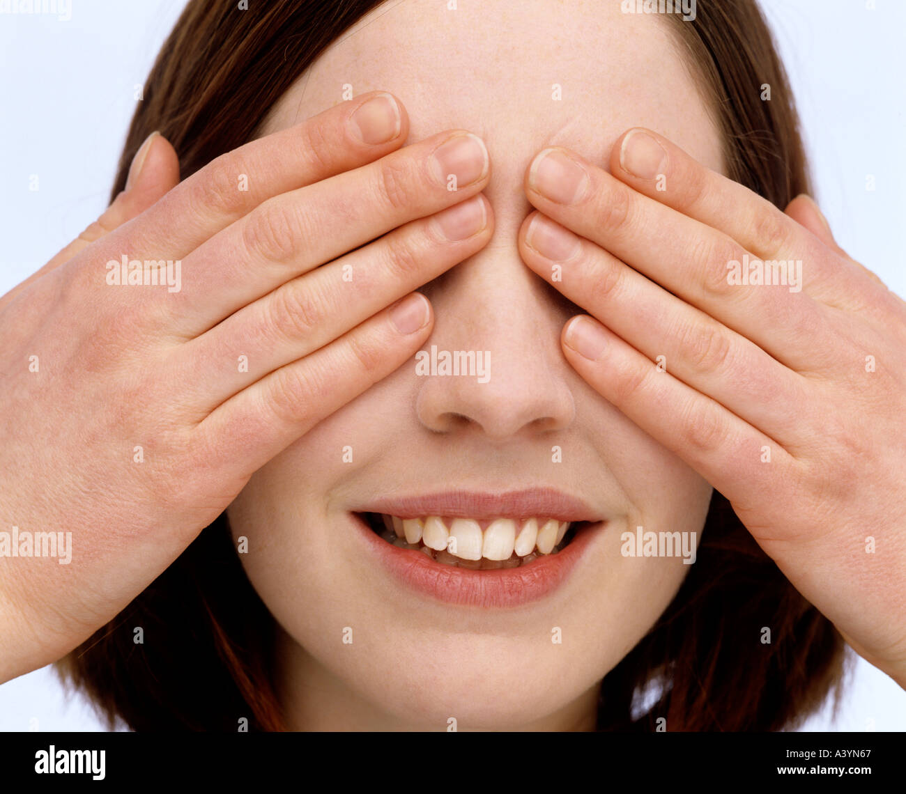 young woman covering her eyes with her hands Stock Photo - Alamy