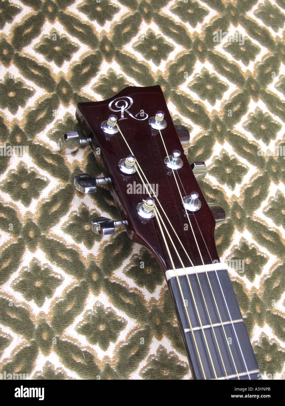 guitar resting on sofa chair Stock Photo - Alamy