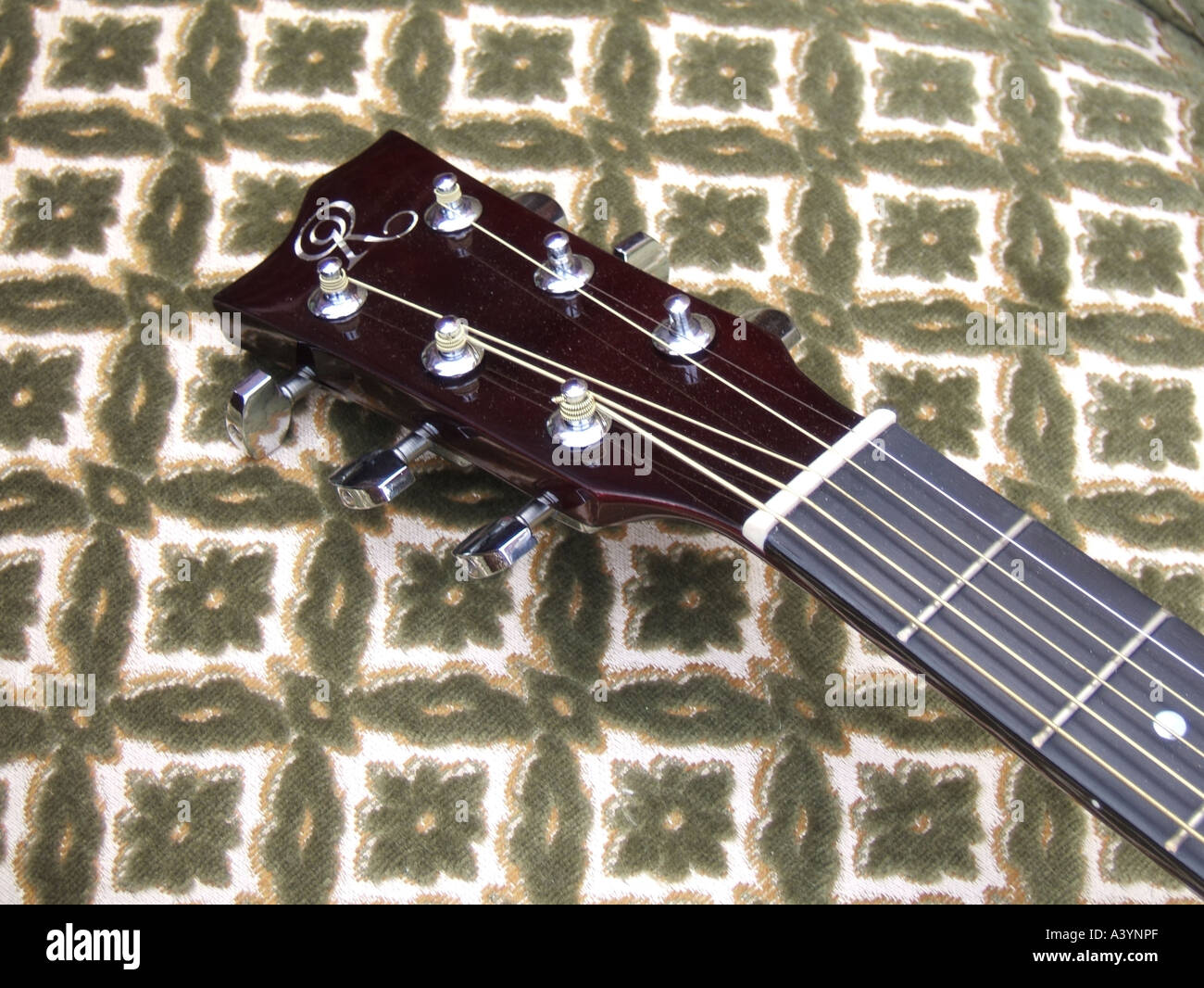 guitar resting on sofa chair Stock Photo - Alamy