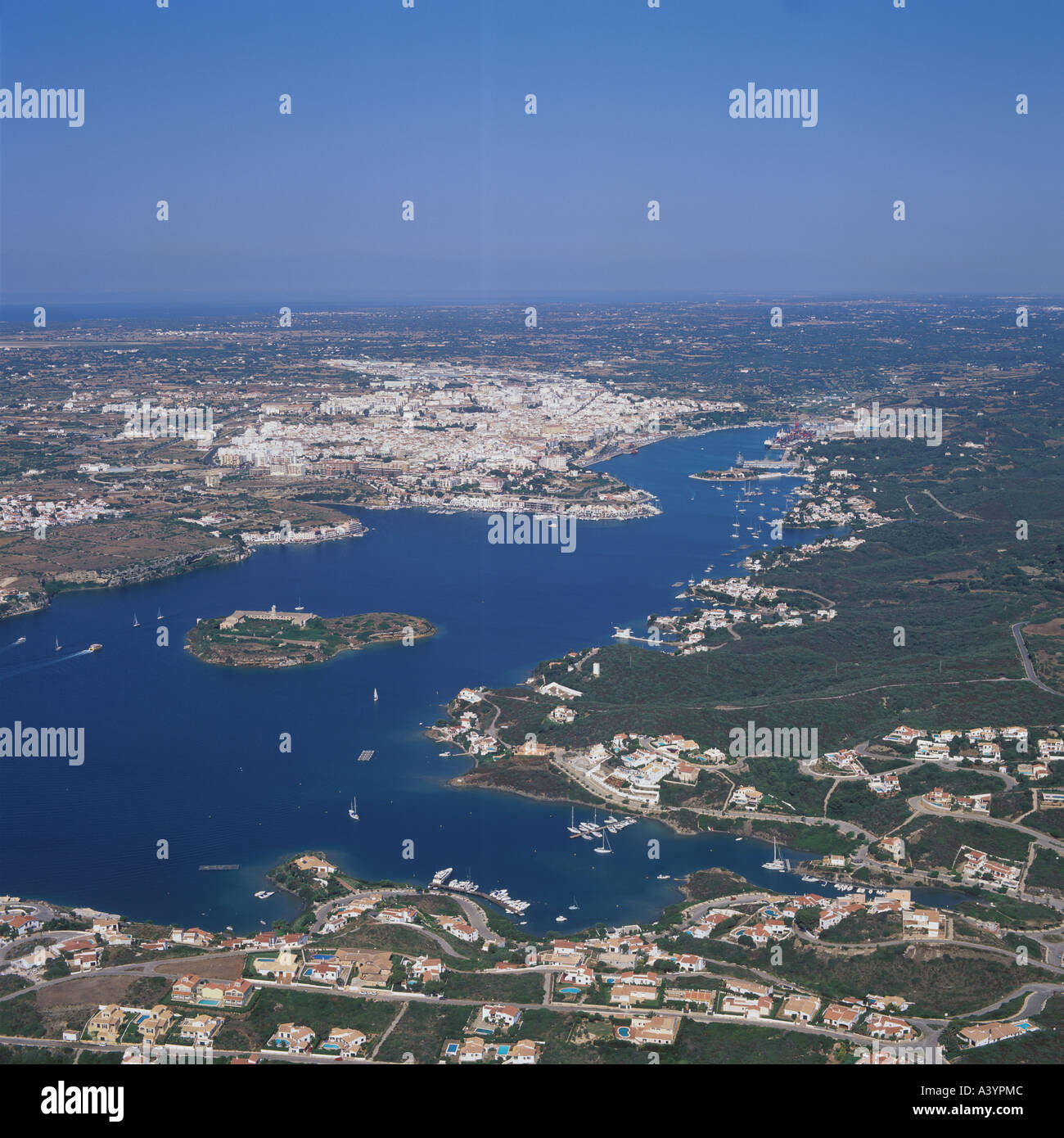 Aerial scene over the sea approaches to the City and Port of Mahon ...