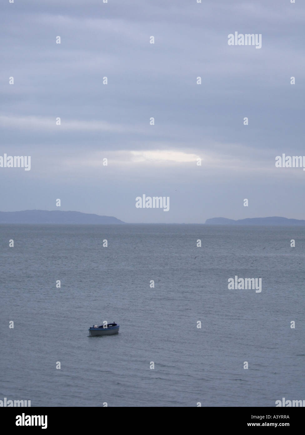 rowing boat on dull sea Stock Photo - Alamy