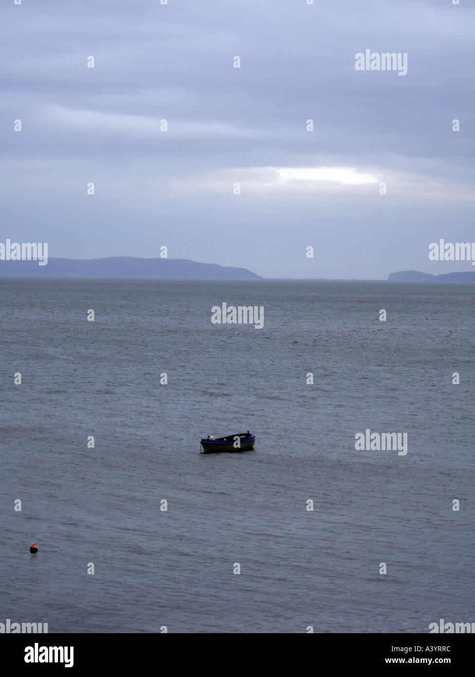rowing boat on dull sea Stock Photo - Alamy