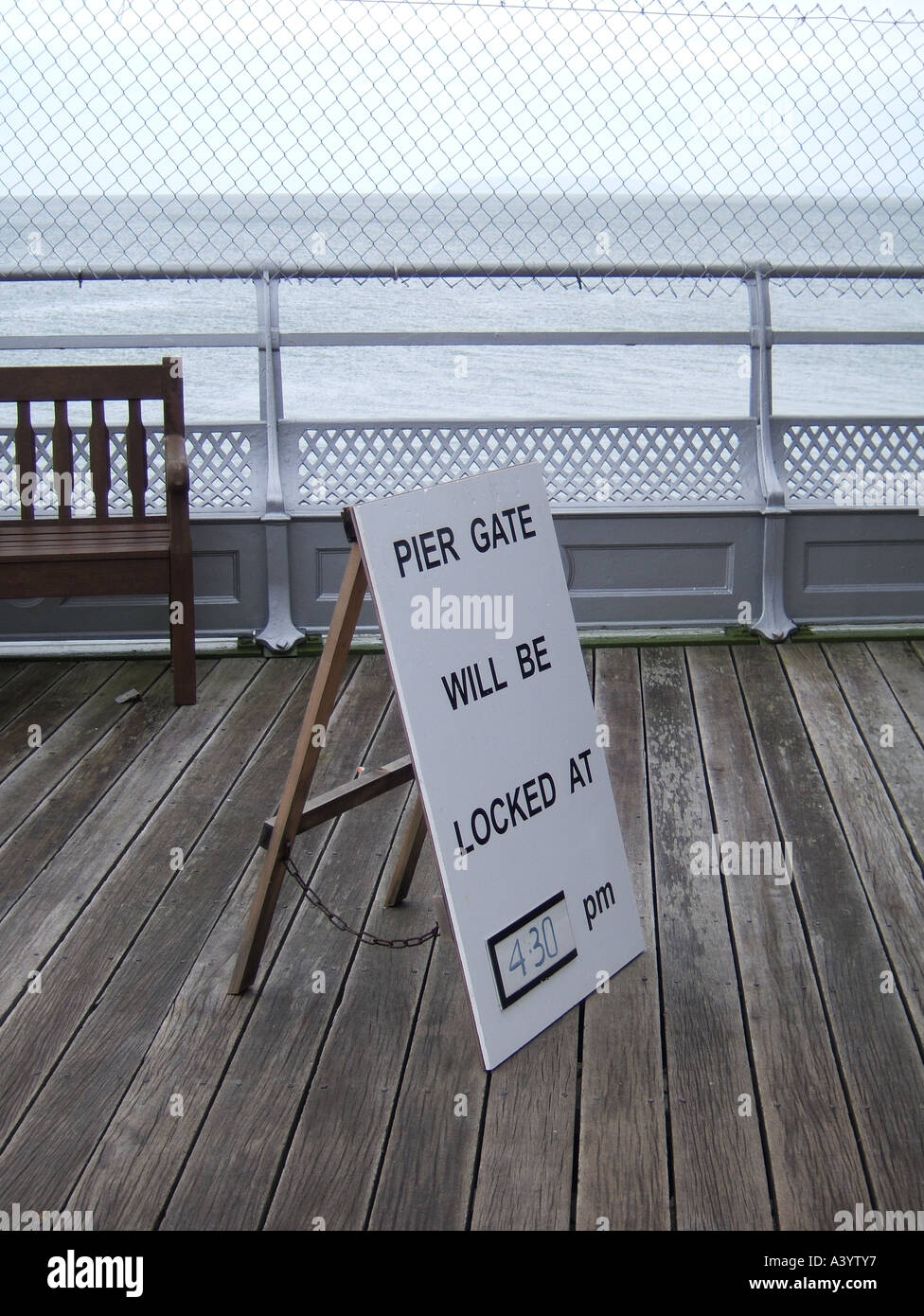 pier closing time notice Stock Photo - Alamy