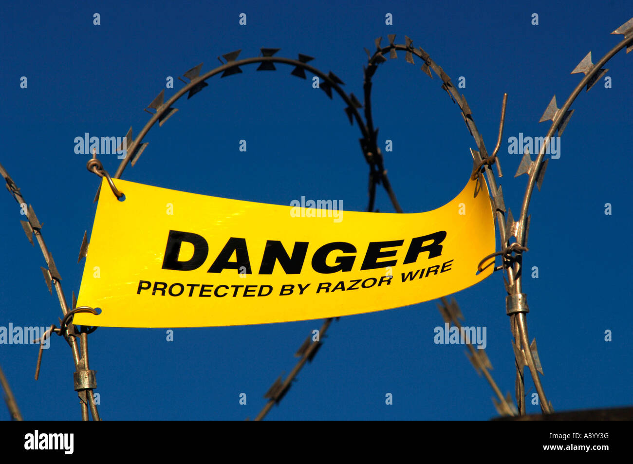 Yellow danger razor wire sign hi-res stock photography and images - Alamy