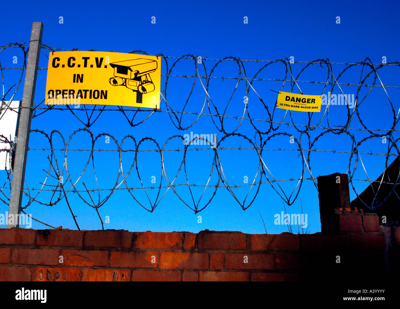 Security Signs Fixed To Razorblade Edged Wiring Stock Photo - Alamy