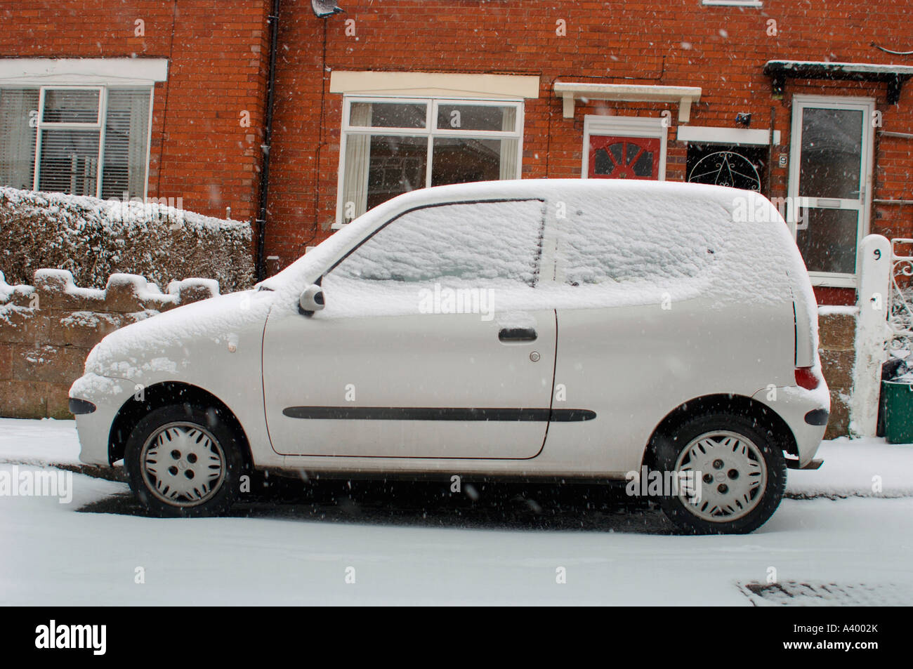 Parked Car Getting Covered By Falling Snow Stock Photo - Alamy