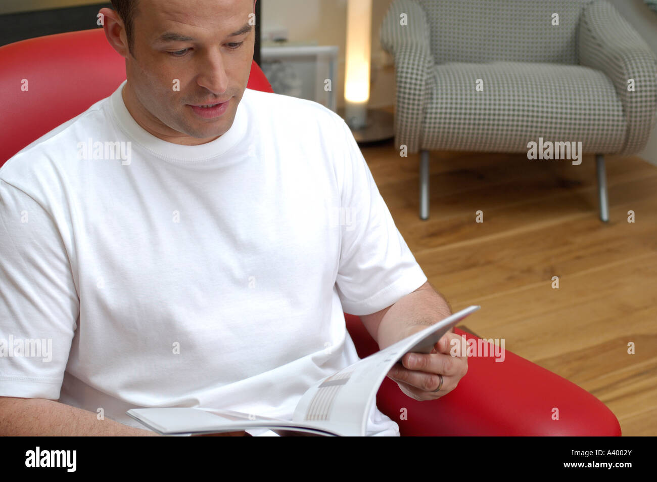 portrait of man reading magazine Stock Photo - Alamy