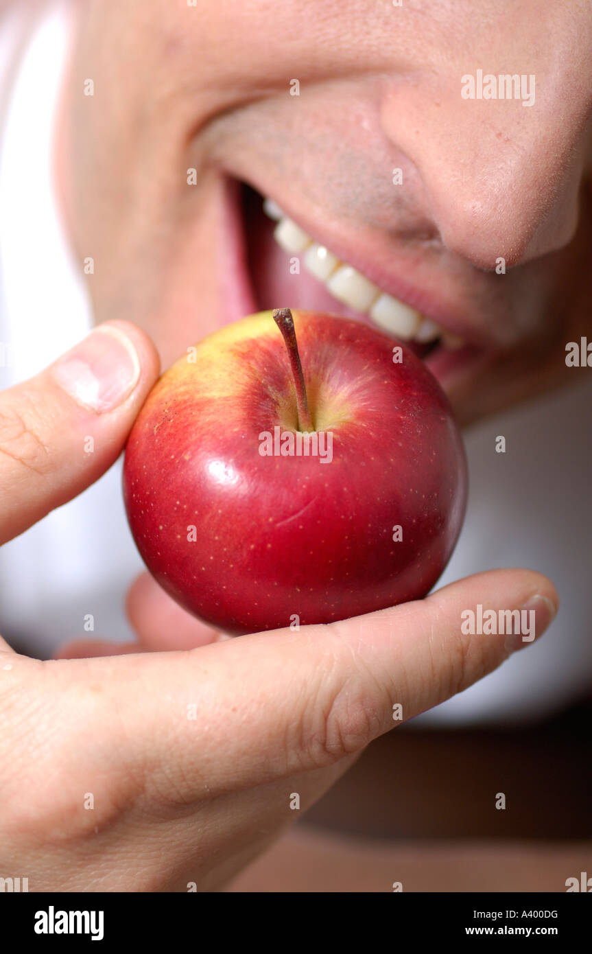 close up of man biting in red apple Stock Photo - Alamy