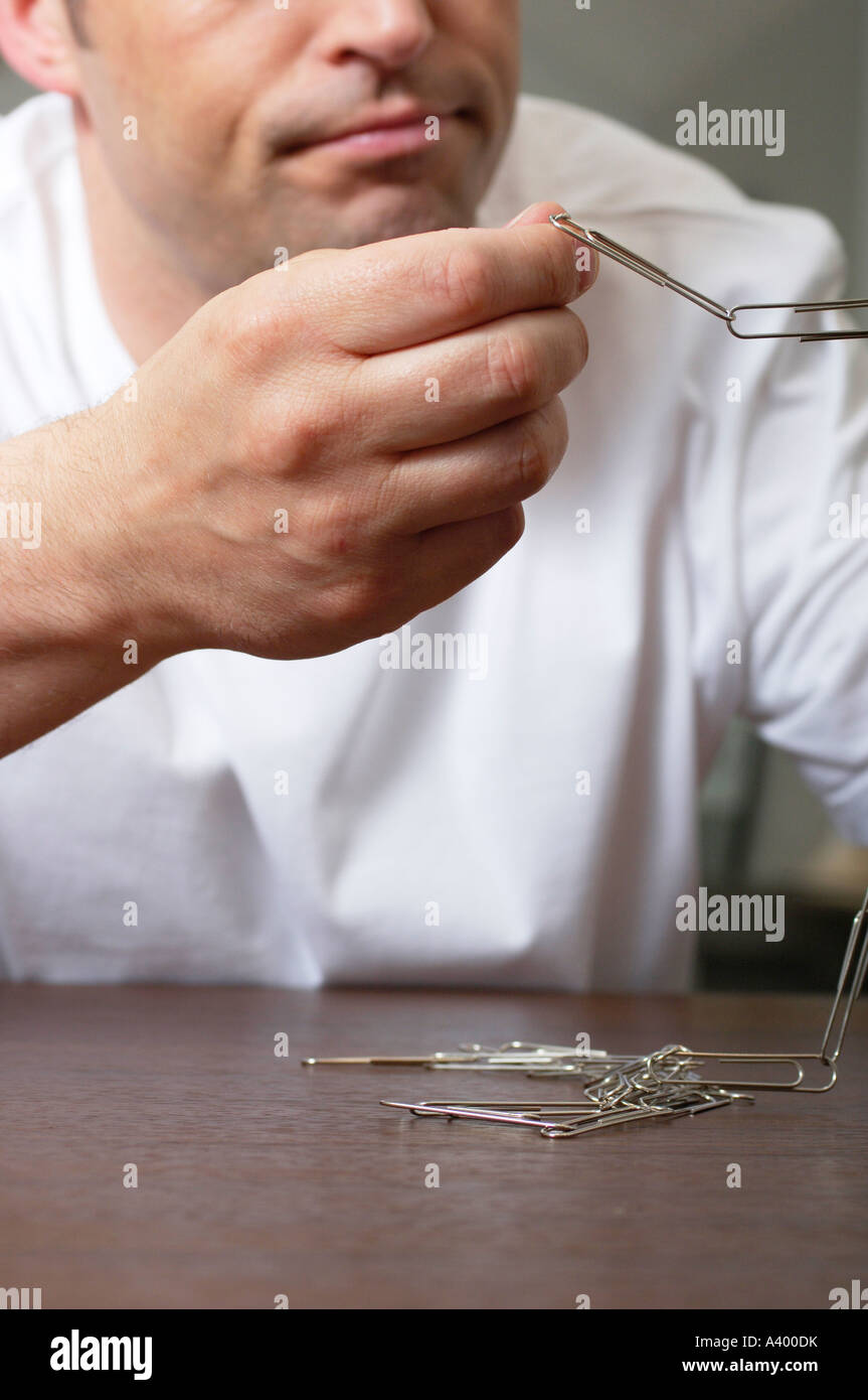 Man making paper clip chain hi-res stock photography and images - Alamy