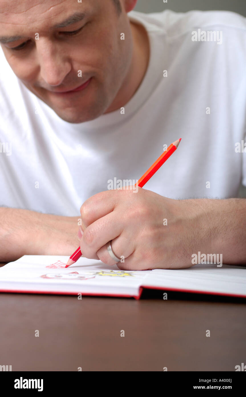 man drawing in book Stock Photo - Alamy
