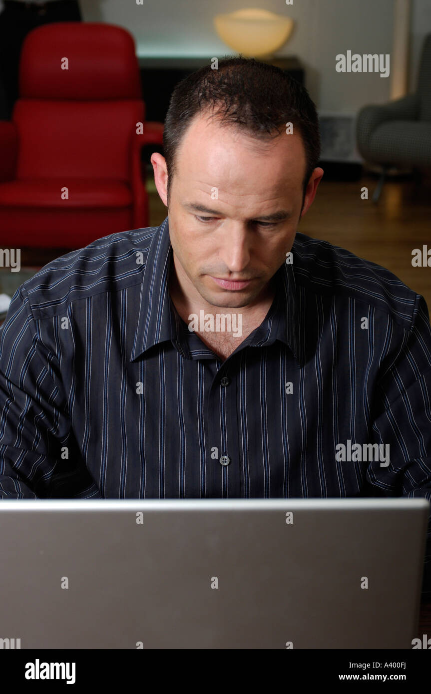 portrait of man working with laptop computer Stock Photo - Alamy