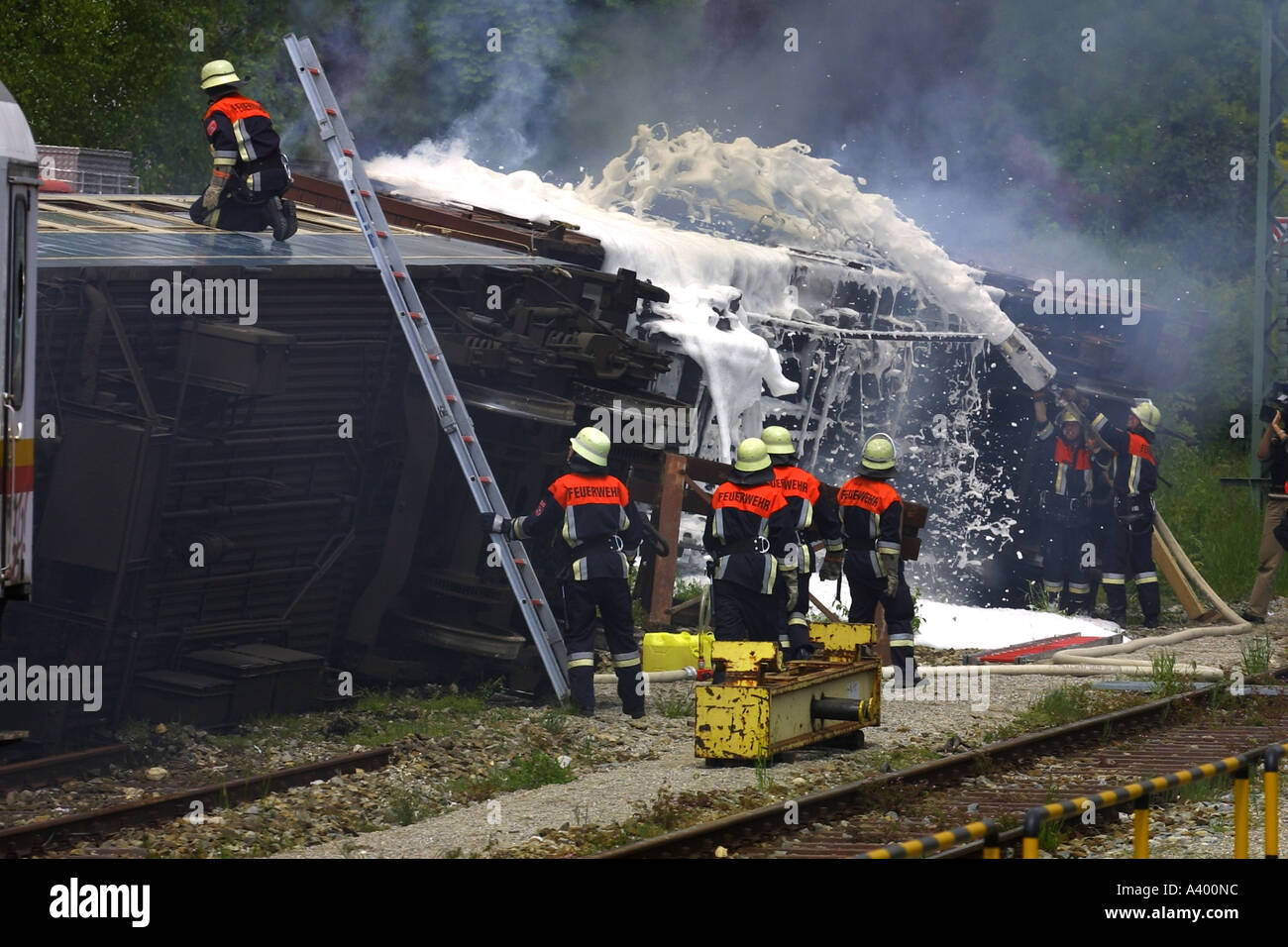 firemen extinguishing fire at a disaster practice train accident Stock ...