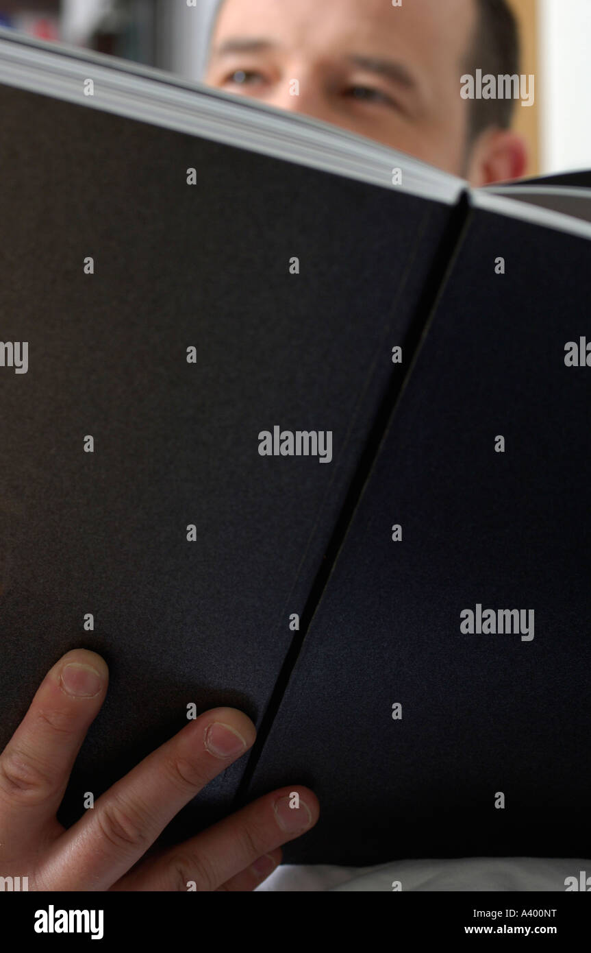 close up of man holding book Stock Photo - Alamy