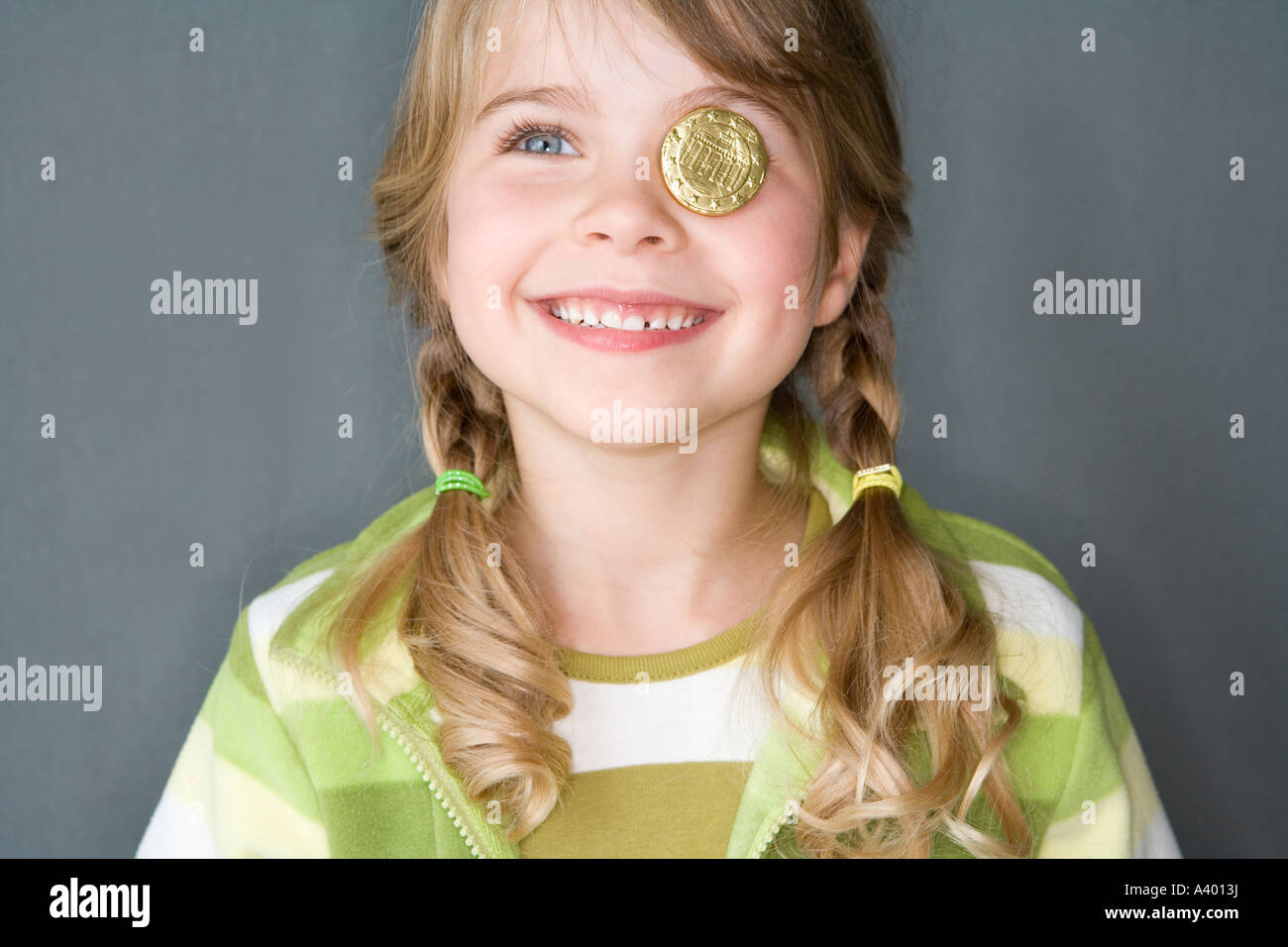 portrait of smiling girl one eye covered with Euro coin Stock Photo - Alamy