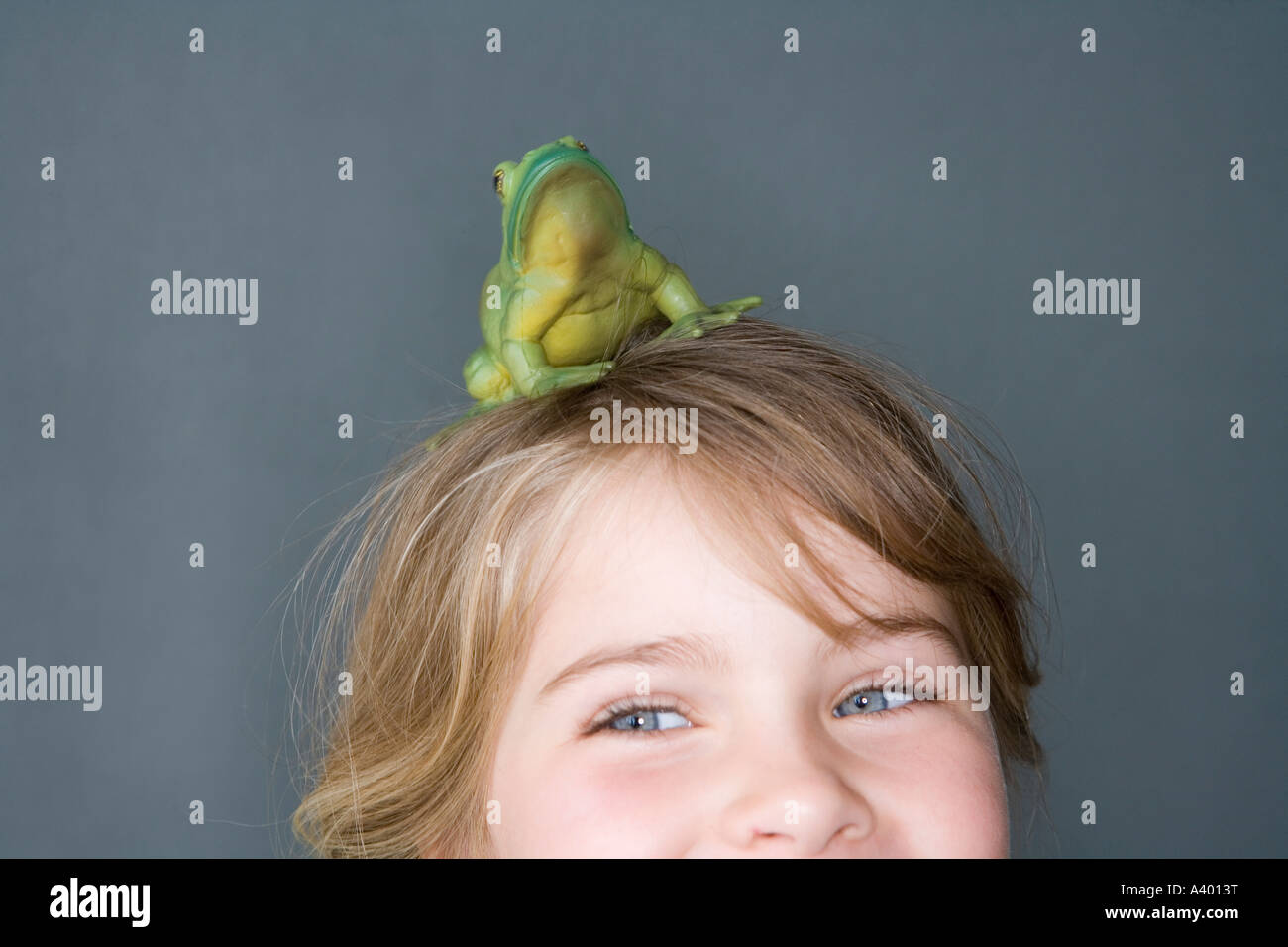 cropped portrait of girl with frog on head Stock Photo - Alamy