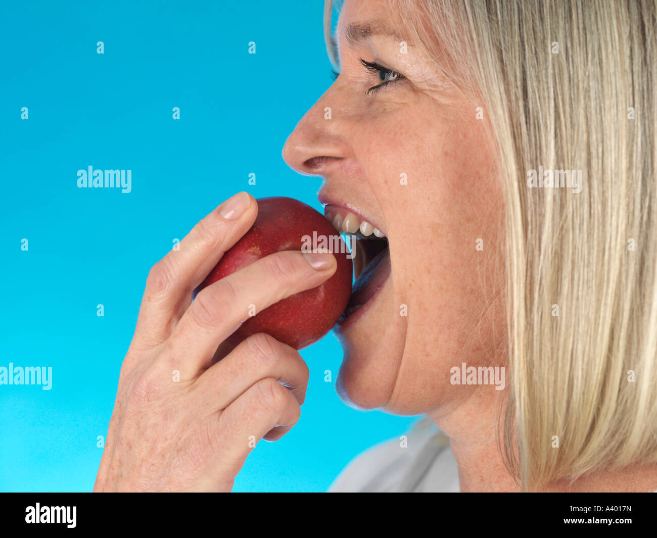Mature Woman Eating an Apple Model Released Stock Photo - Alamy