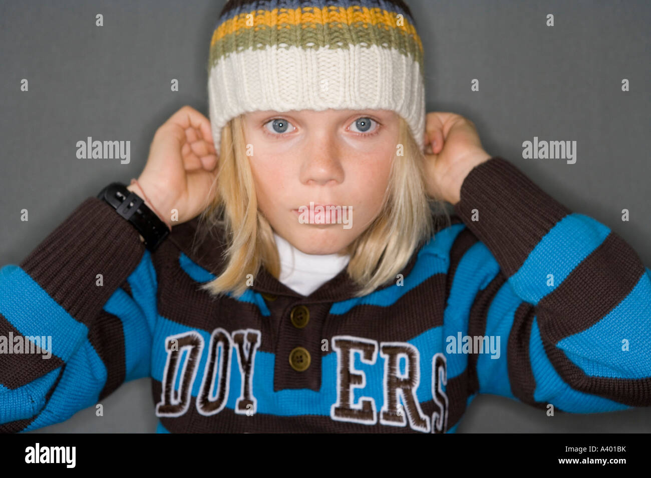 boy putting on winter hat Stock Photo - Alamy
