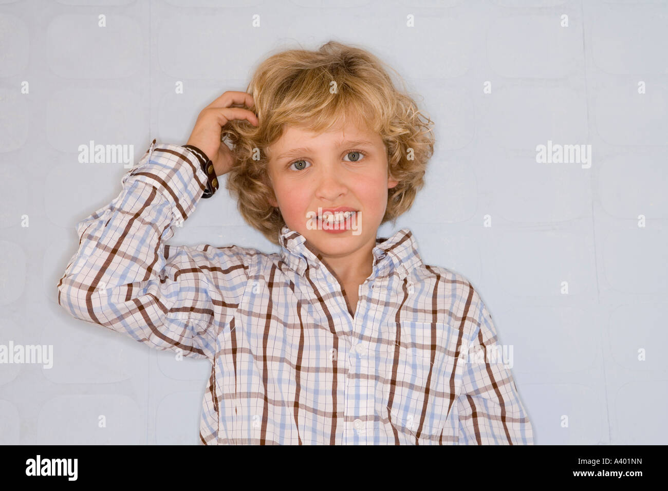 portrait of young boy scratching his head Stock Photo - Alamy