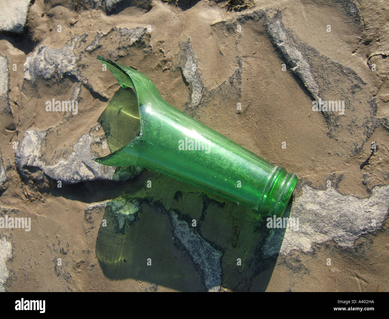 smashed green bottle on river bank Stock Photo - Alamy