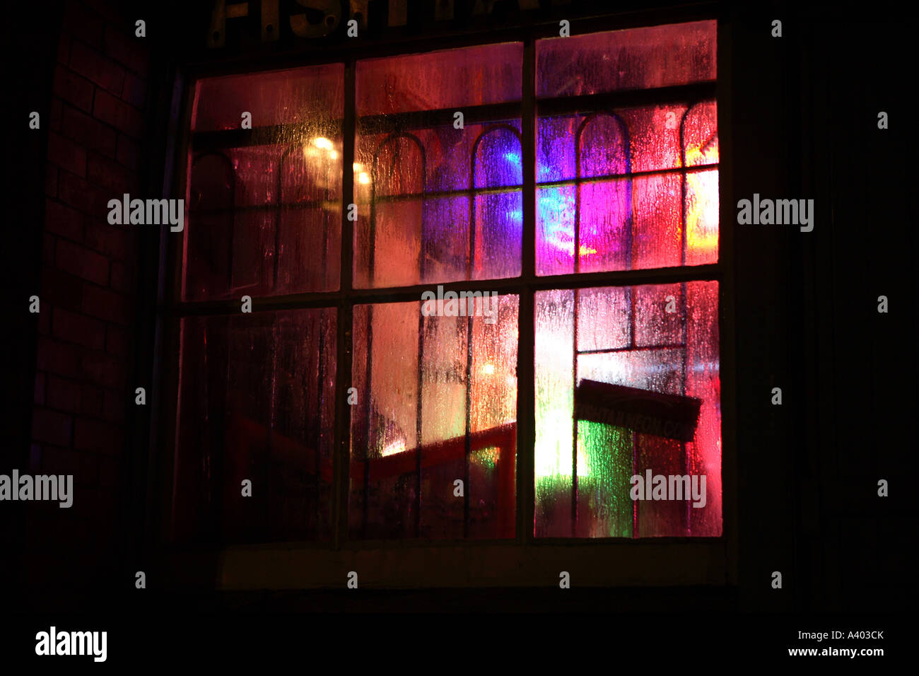 ABSTRACT Fishtail neon signmakers shop window at night Brighton East ...