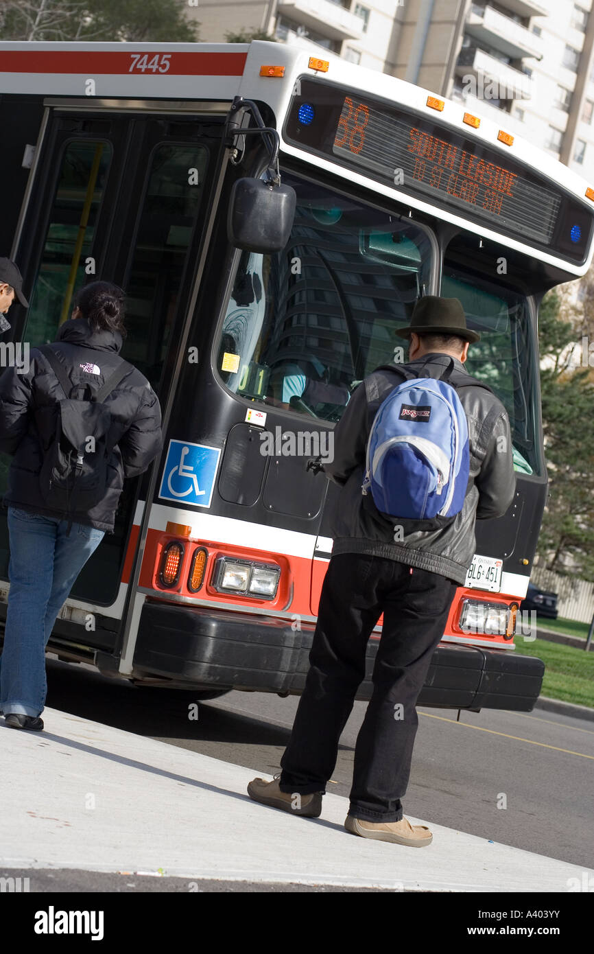 Canadian bus stop, people getting onboard Stock Photo - Alamy