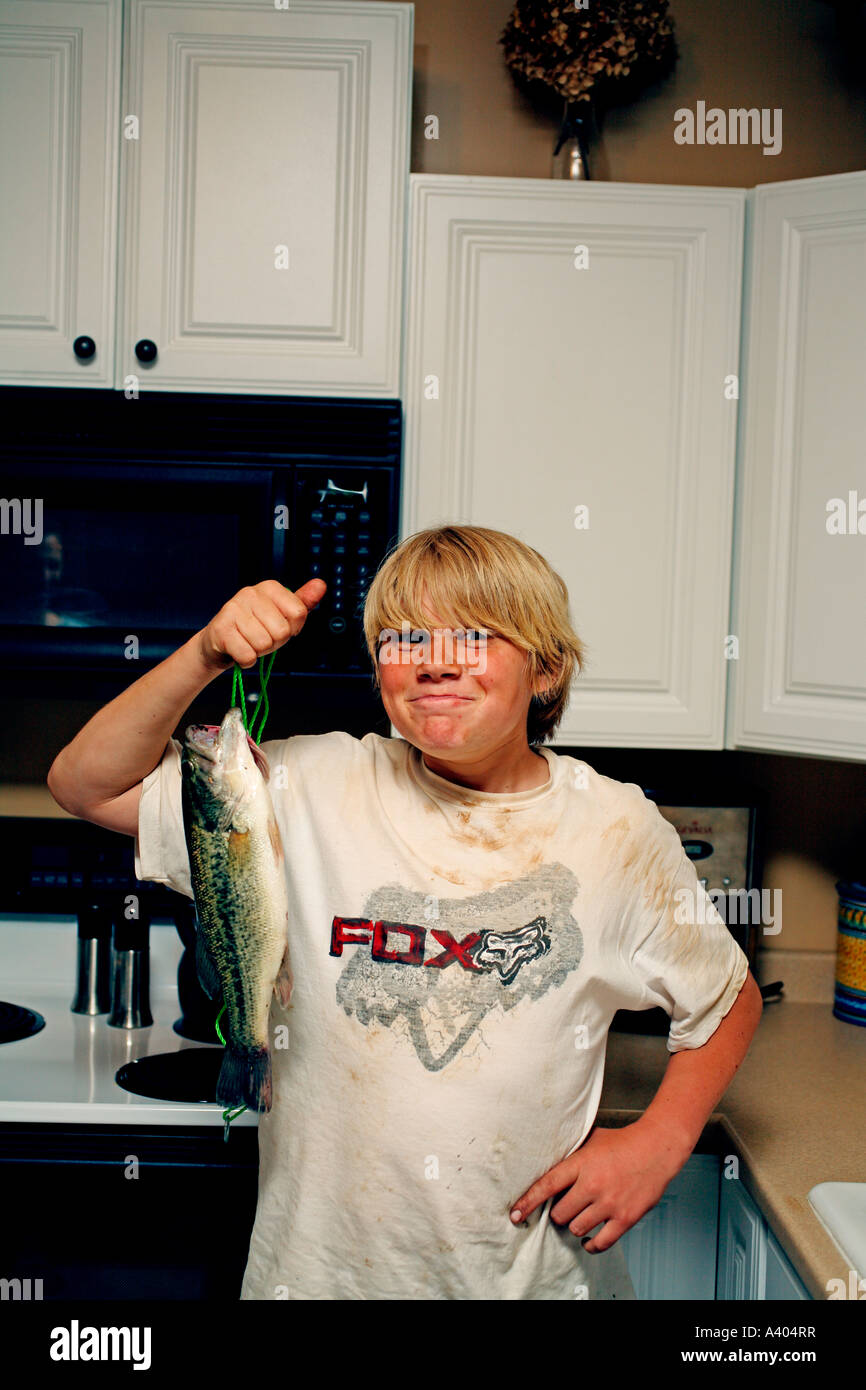 Boy with a fish he caught Stock Photo - Alamy