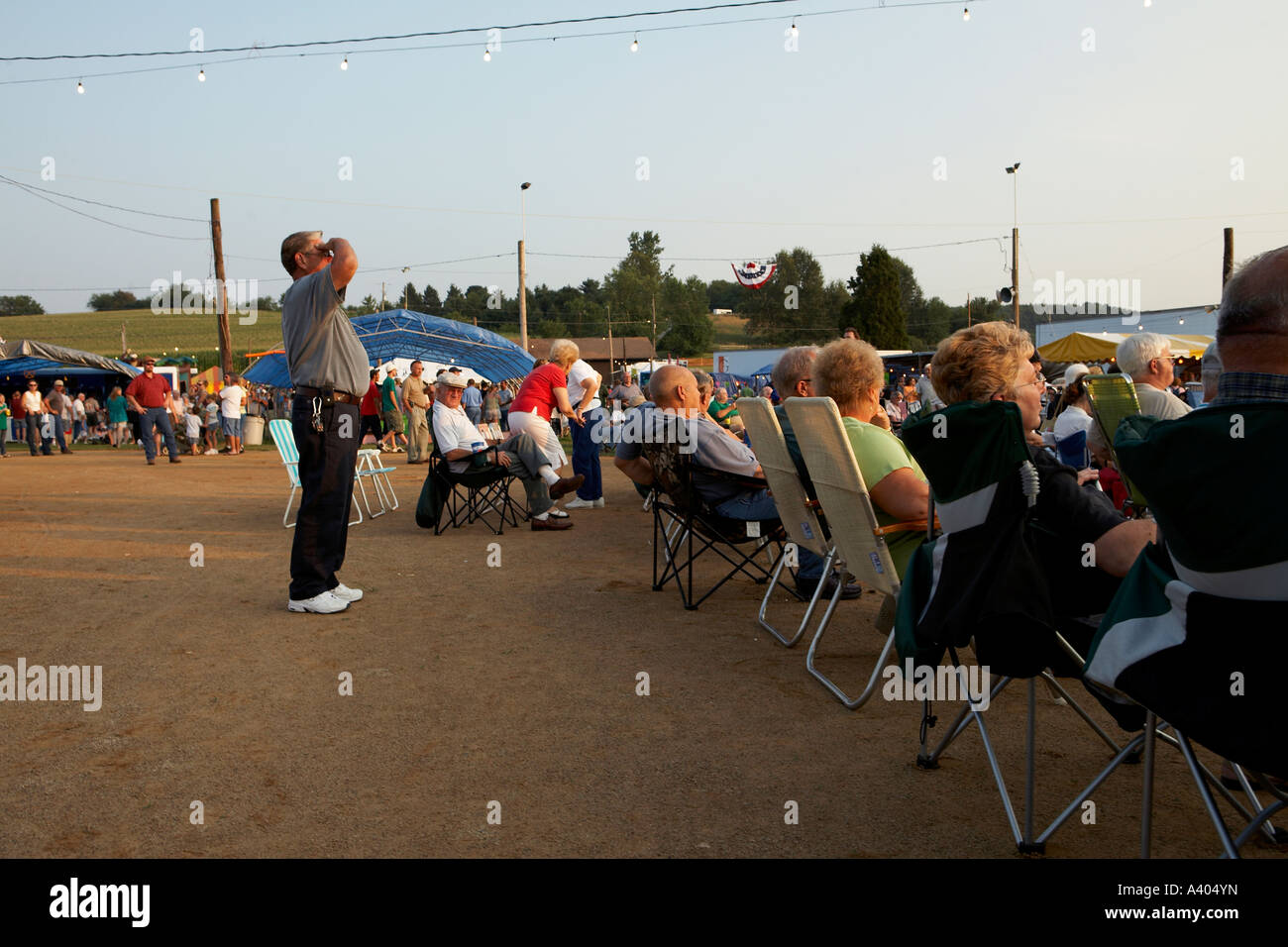 Man watching a concert at a fair Stock Photo - Alamy
