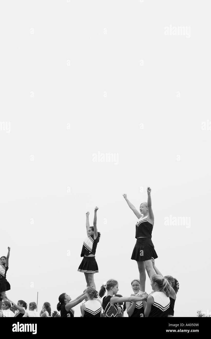 Cheerleaders cheerleading at a hight school football game Stock Photo ...