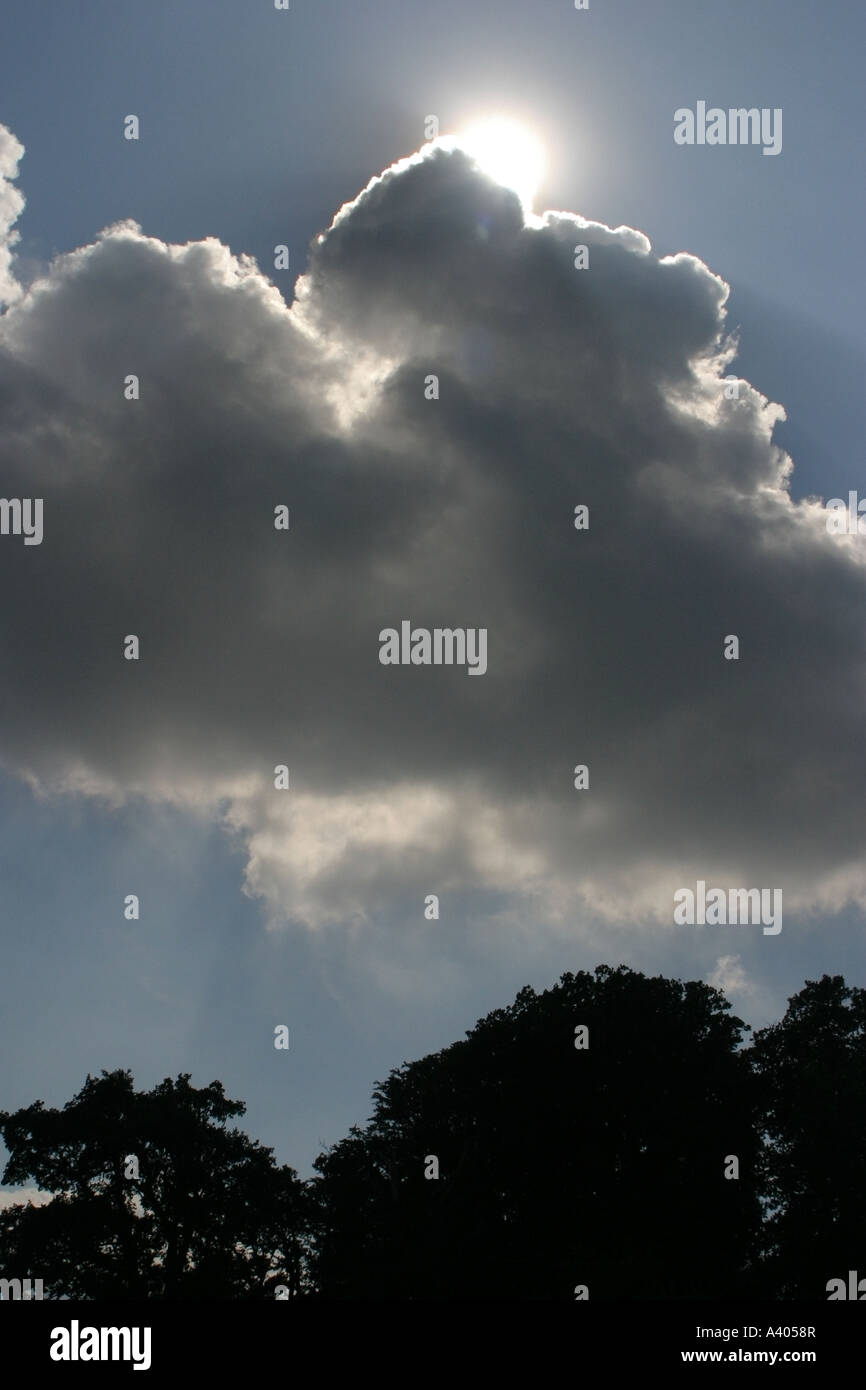Sun emerging from large cloud Stock Photo - Alamy