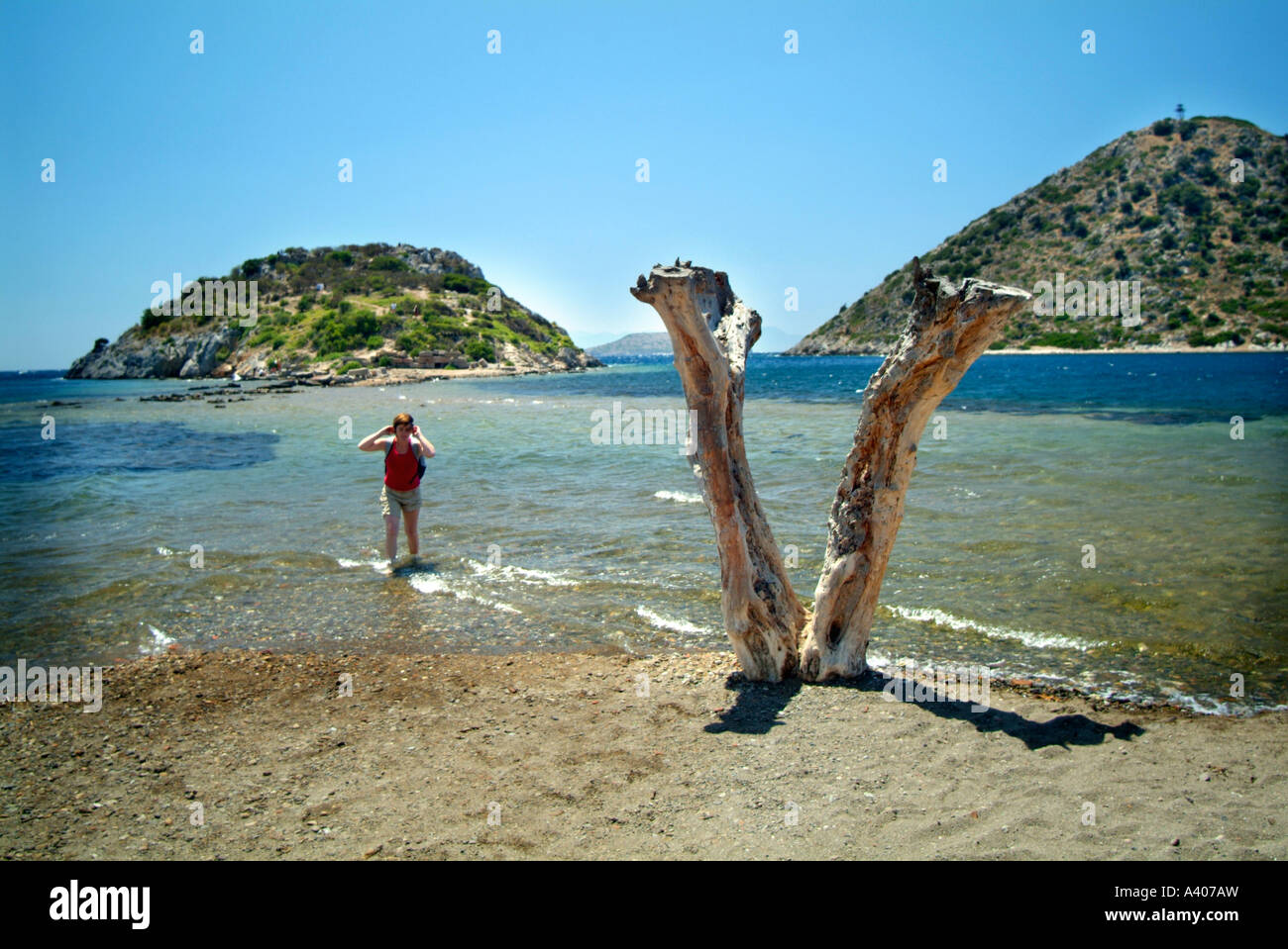 girl wading ashore from Rabbit Island Gumusluk Turkey Stock Photo - Alamy