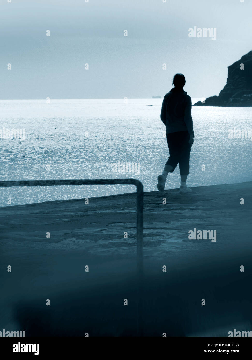 walking on sea wall at howth ireland Stock Photo - Alamy