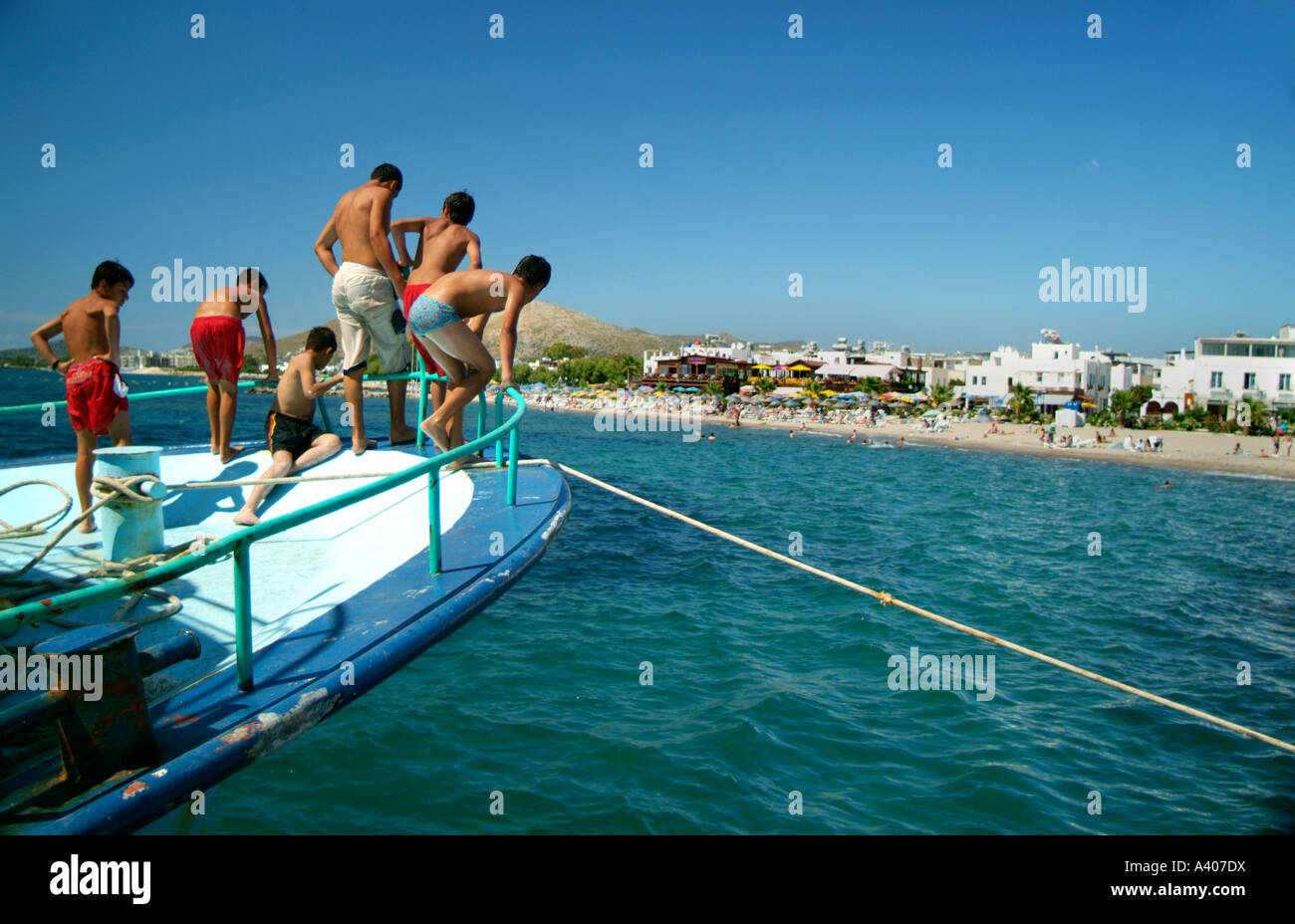 boys diving off boat at turgutreis turkey Stock Photo - Alamy