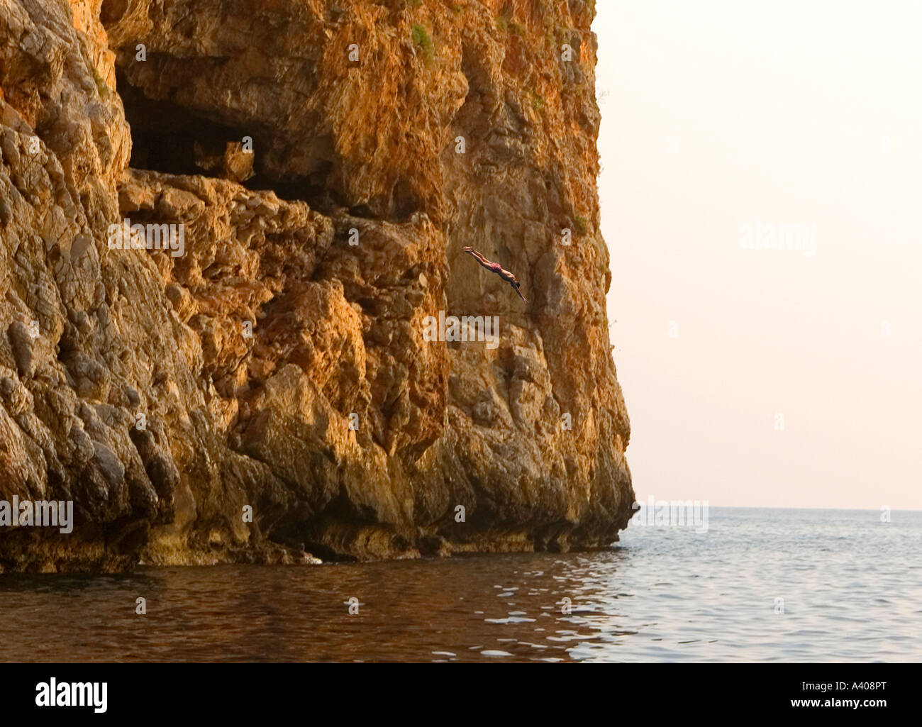 Man jumps into sea from cave on Kale Mt Alanya Turkey Stock Photo - Alamy