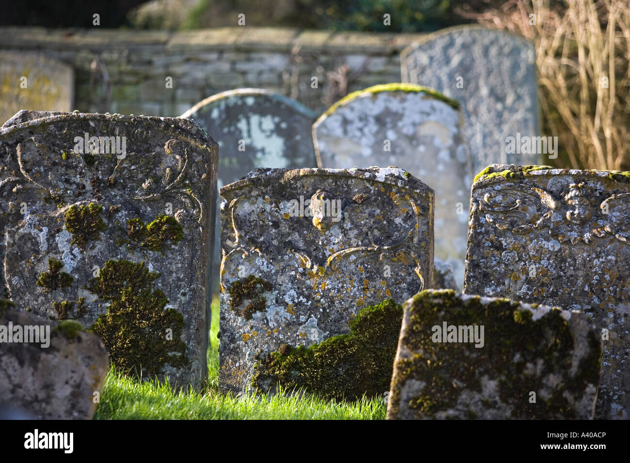 Old gravestones in the graveyard of Little Barrington Church, Cotswolds ...