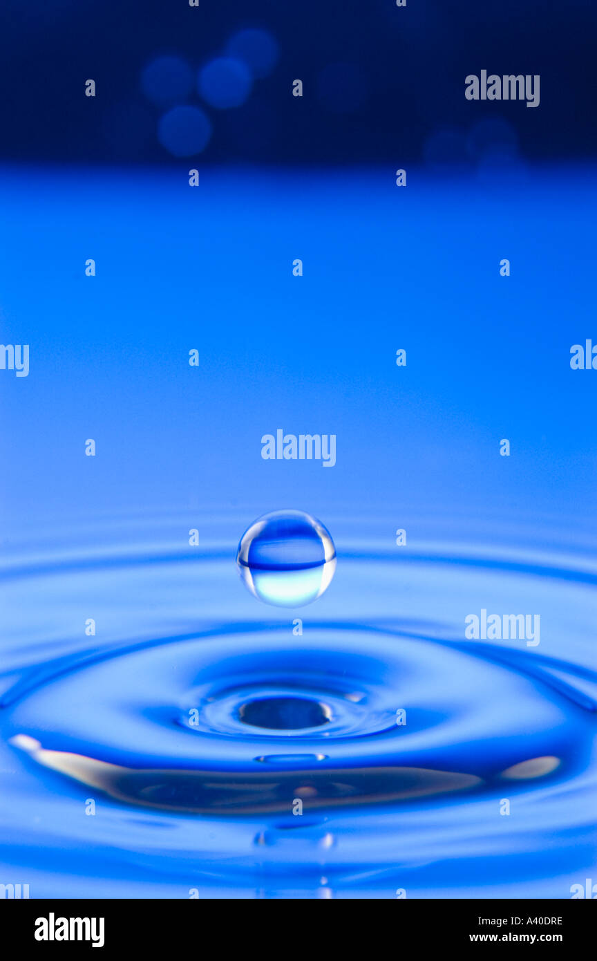 Single water drop into water Stock Photo - Alamy