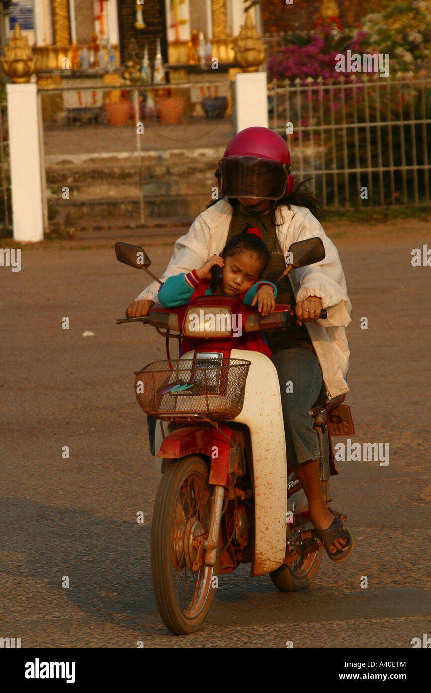 little girl talking on a phone during her ride on as mall motorcycle ...