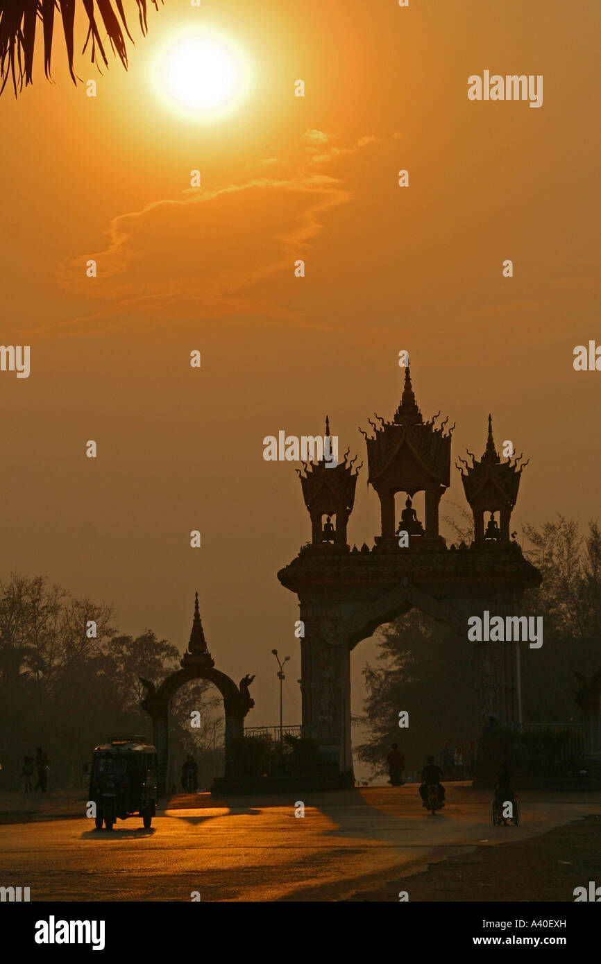 sunset the entrance gate to Wat That Luang aerea Stock Photo - Alamy