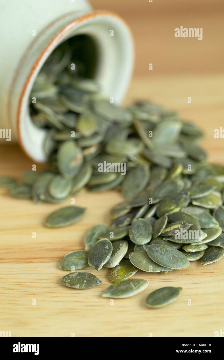 pumpkin seeds spilling from a pot Stock Photo - Alamy