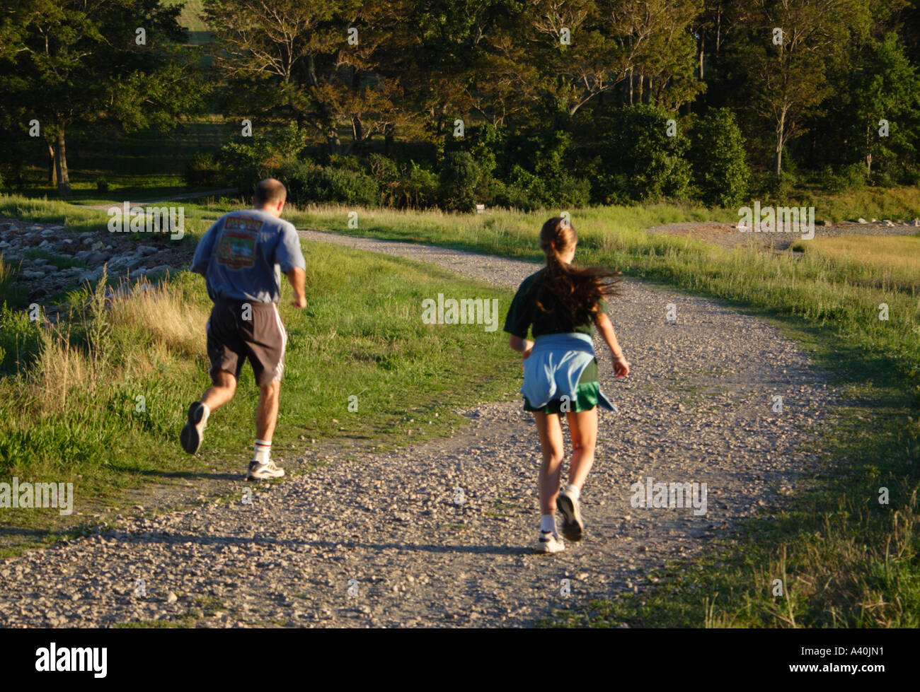 Father and daughter run in a nature preserve Stock Photo - Alamy