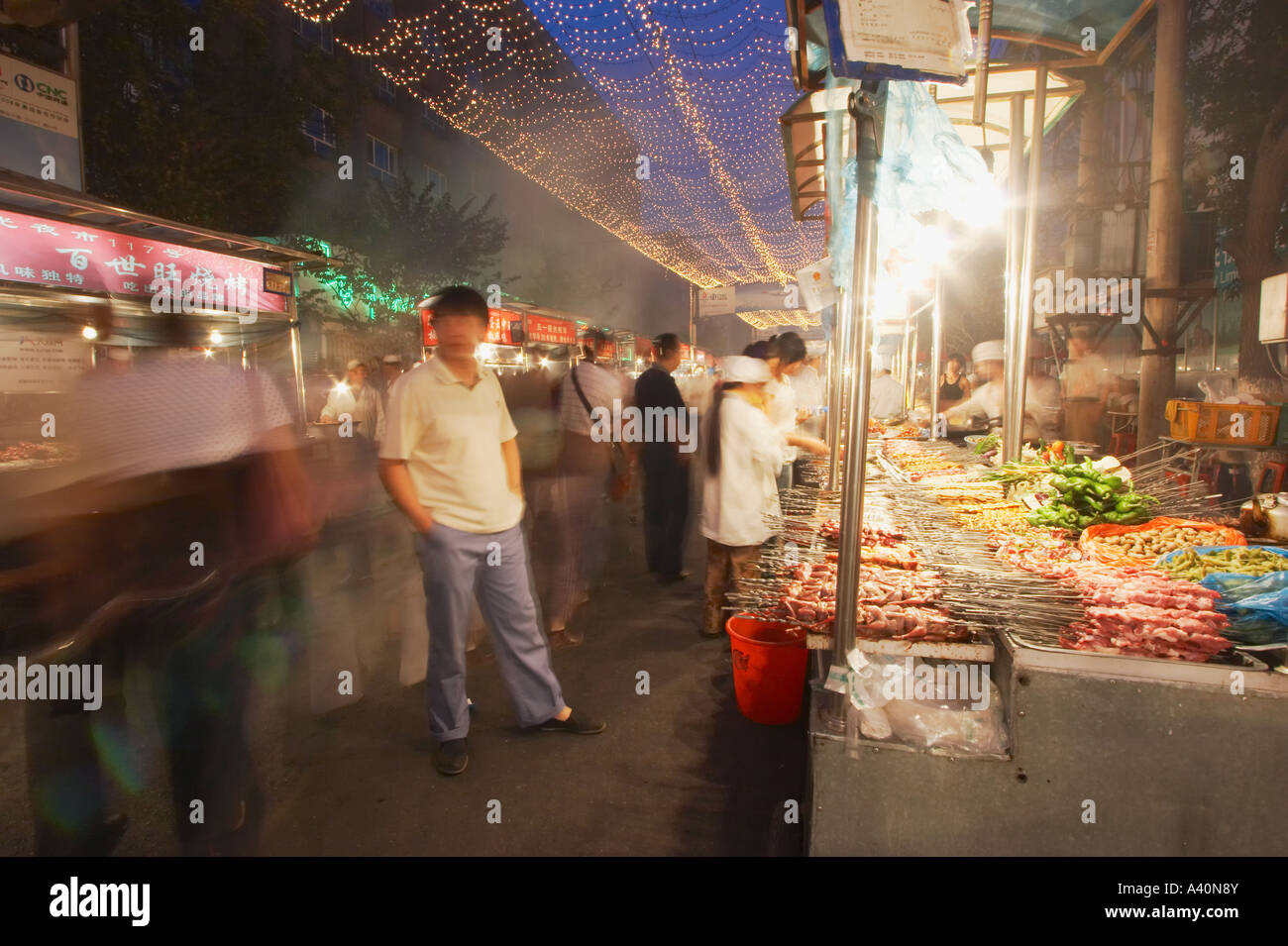 Pedestrians walk past stalls hi-res stock photography and images - Alamy