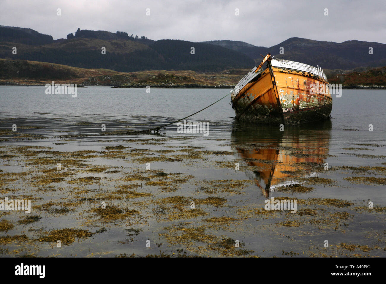 A PARTIALLY SUNKEN BOAT IN A SEA LOCH, SCOTLAND Stock Photo - Alamy