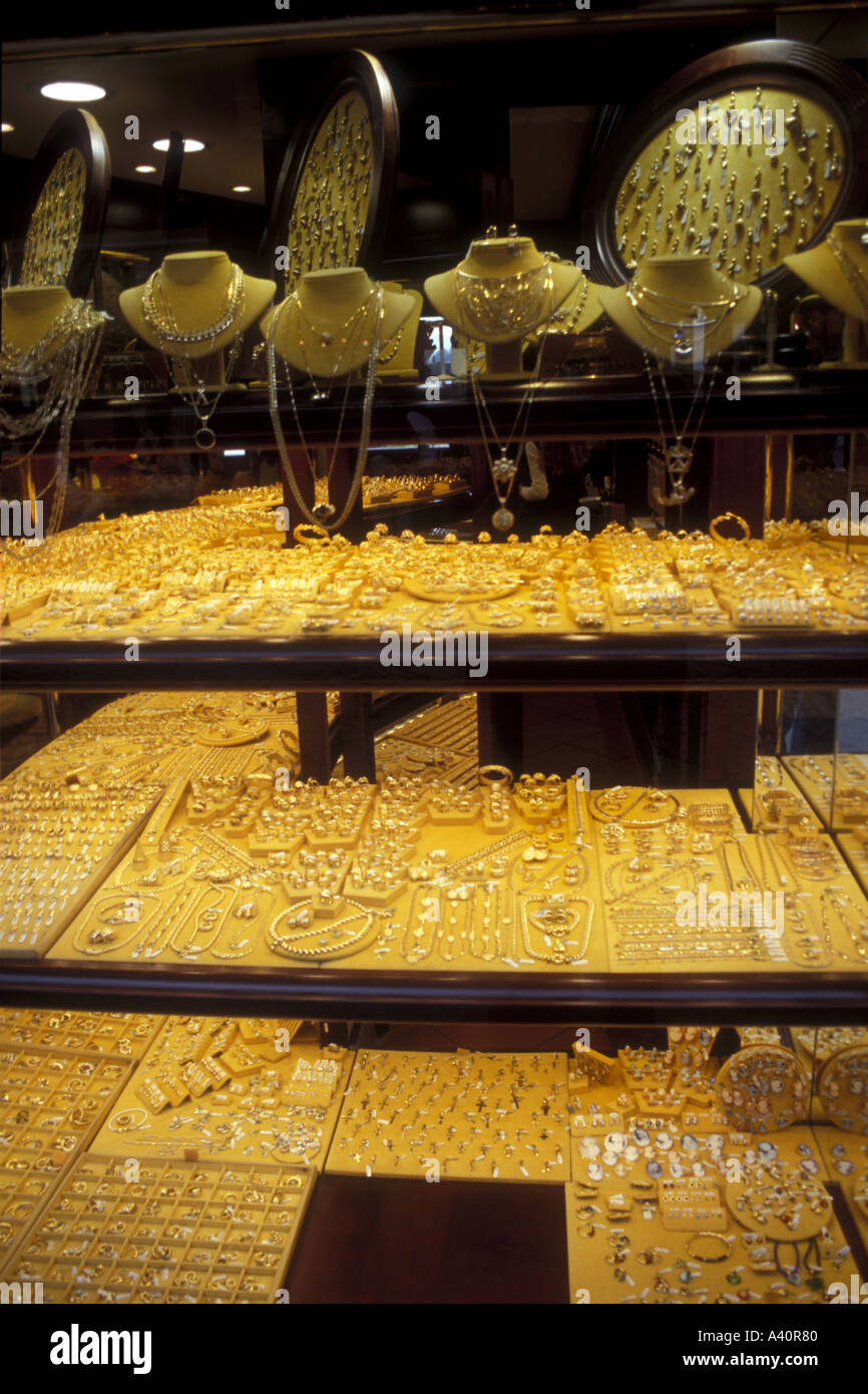 Gold jewelry for sale in a shop window on the Ponte Vecchio bridge over ...
