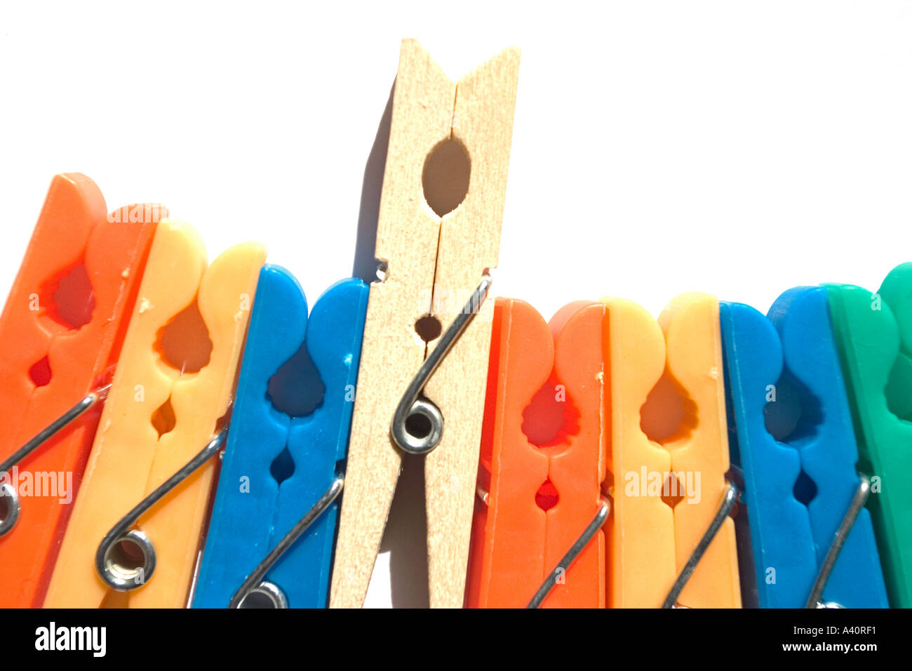 Colored pegs with one different of the similar group Stock Photo - Alamy