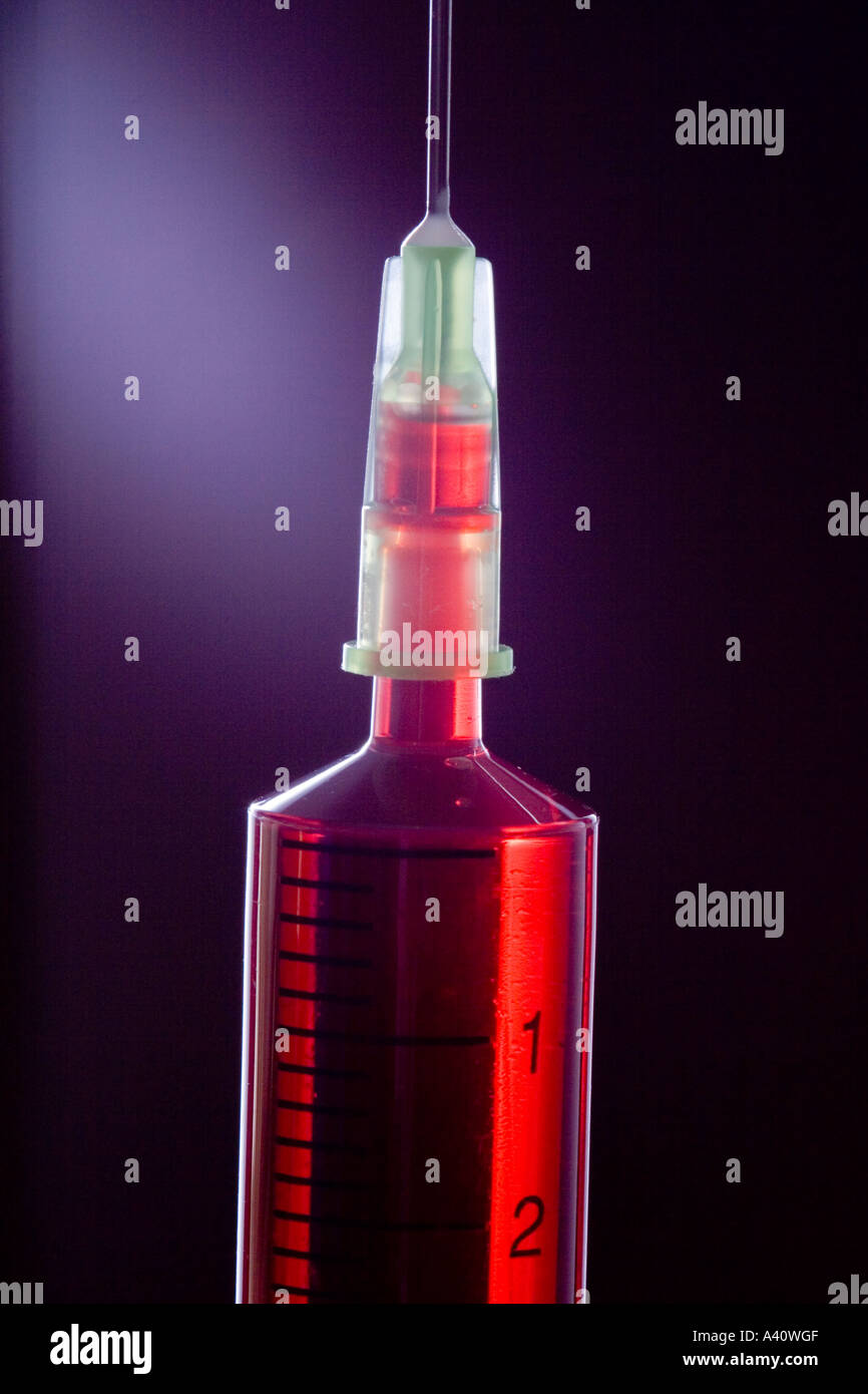 "Blood" filled syringe with hypodermic needle. Black background Stock ...