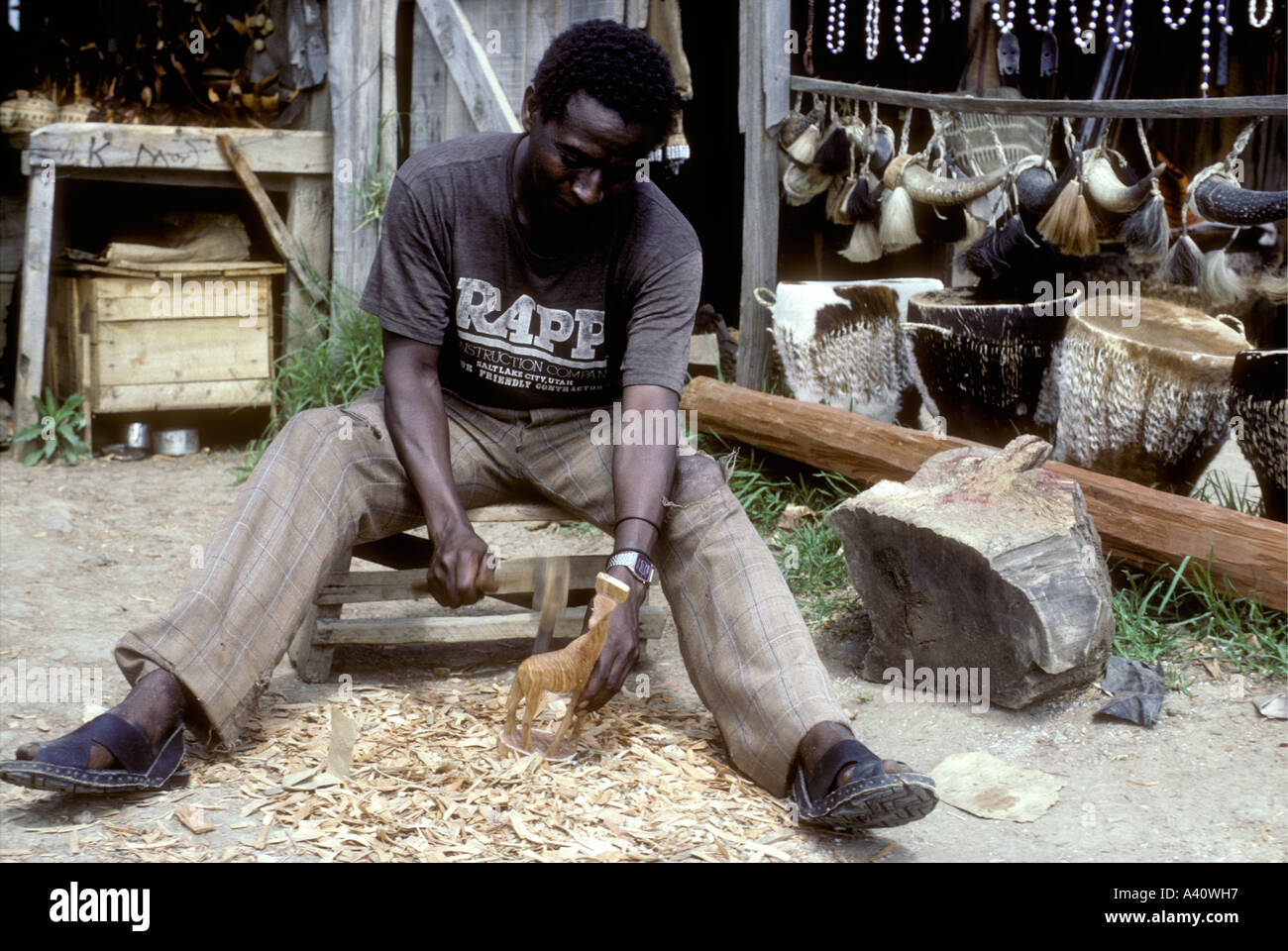Man carving a giraffe at a duka in Nanyuki Kenya East Africa Stock ...