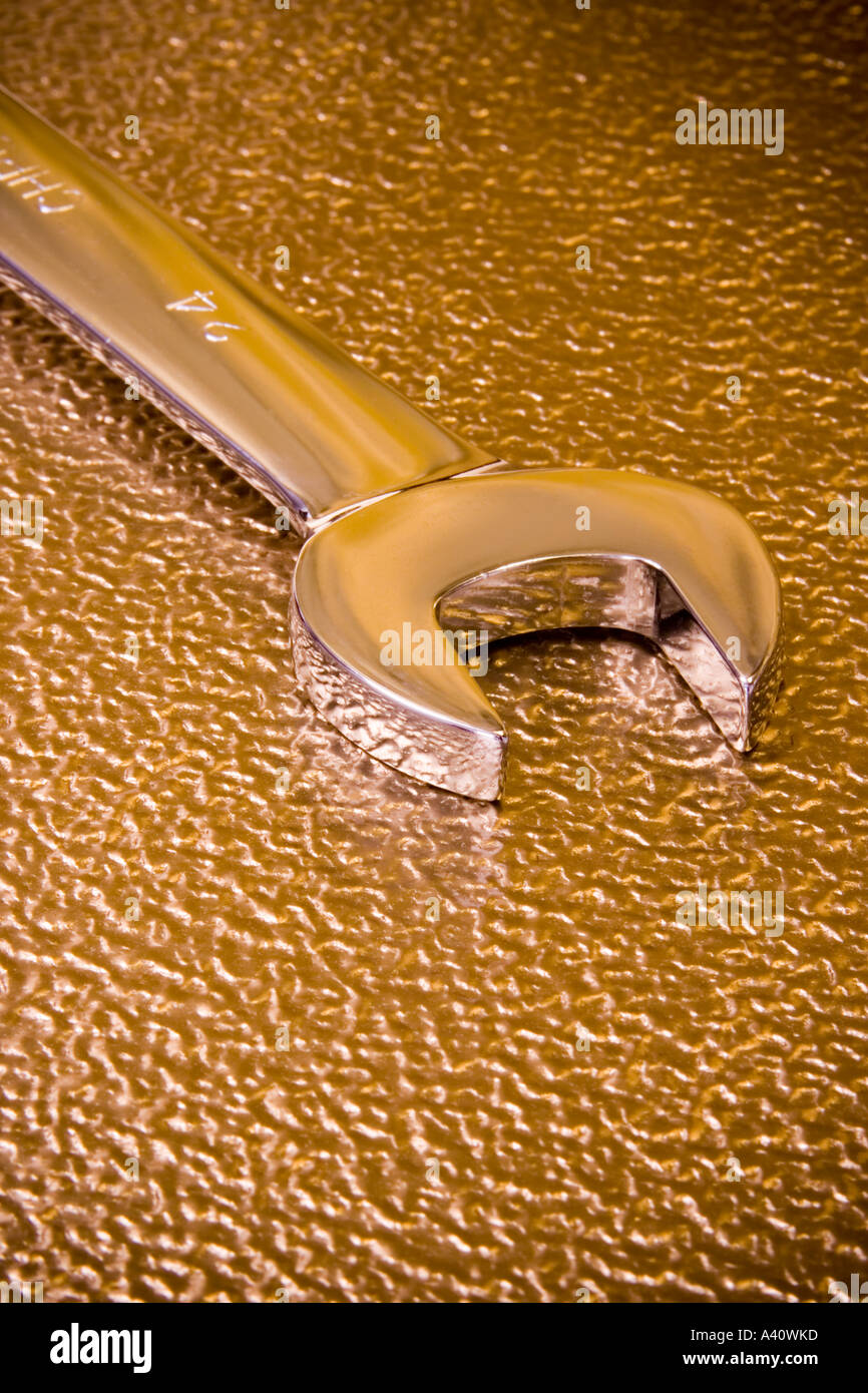 Single spanner against beaten copper background. Golden lighting Stock ...