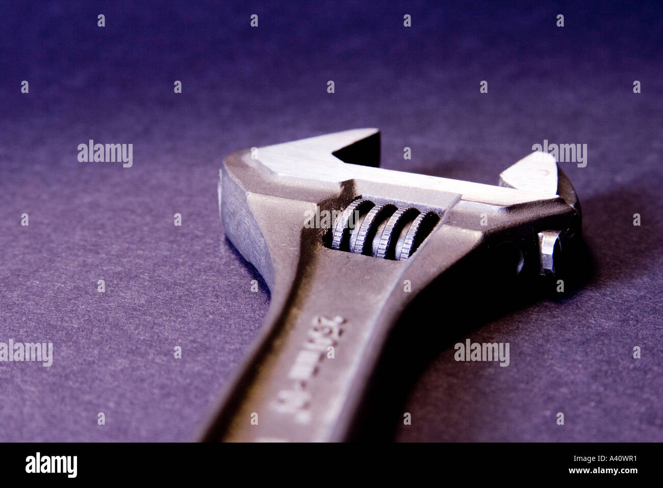 Adjustable spanner against black background Stock Photo - Alamy
